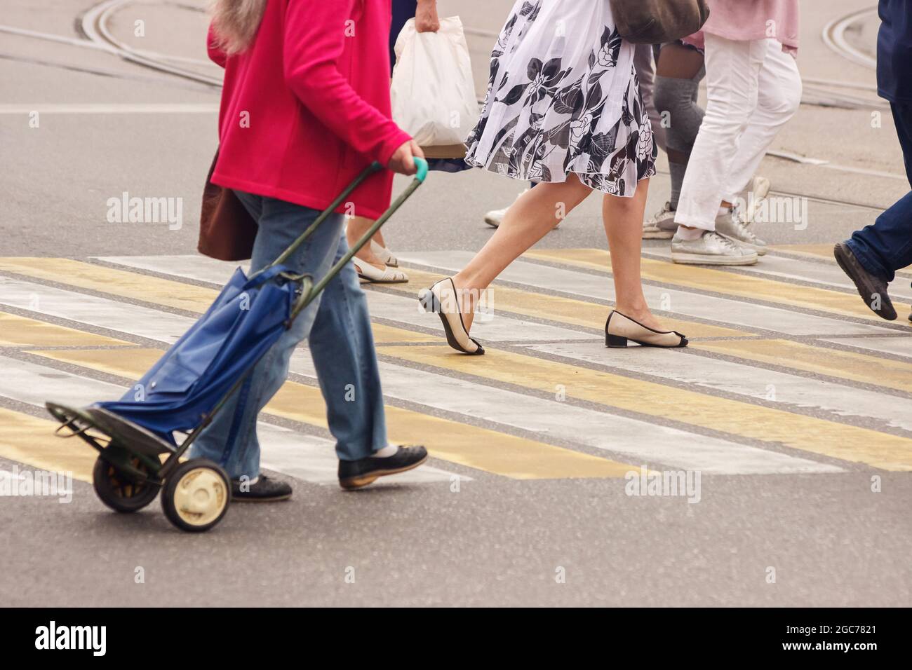 pedestrians walking on a crosswalk on sunny summer day Stock Photo - Alamy