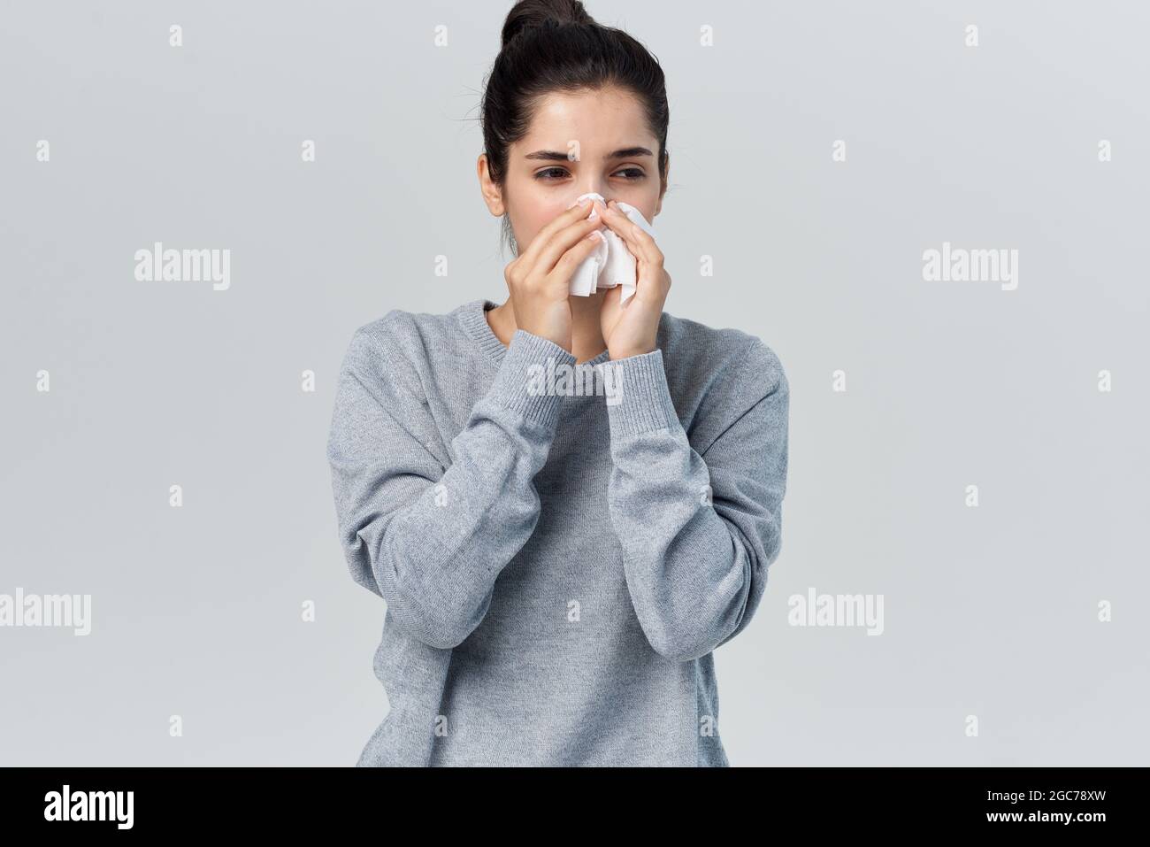 woman wiping her nose with a handkerchief health problems allergy ...