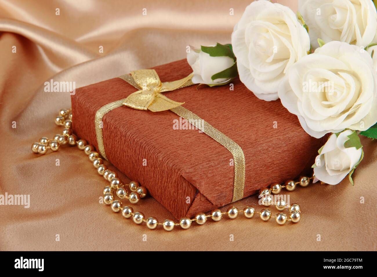 Romantic parcel on gold cloth background Stock Photo - Alamy