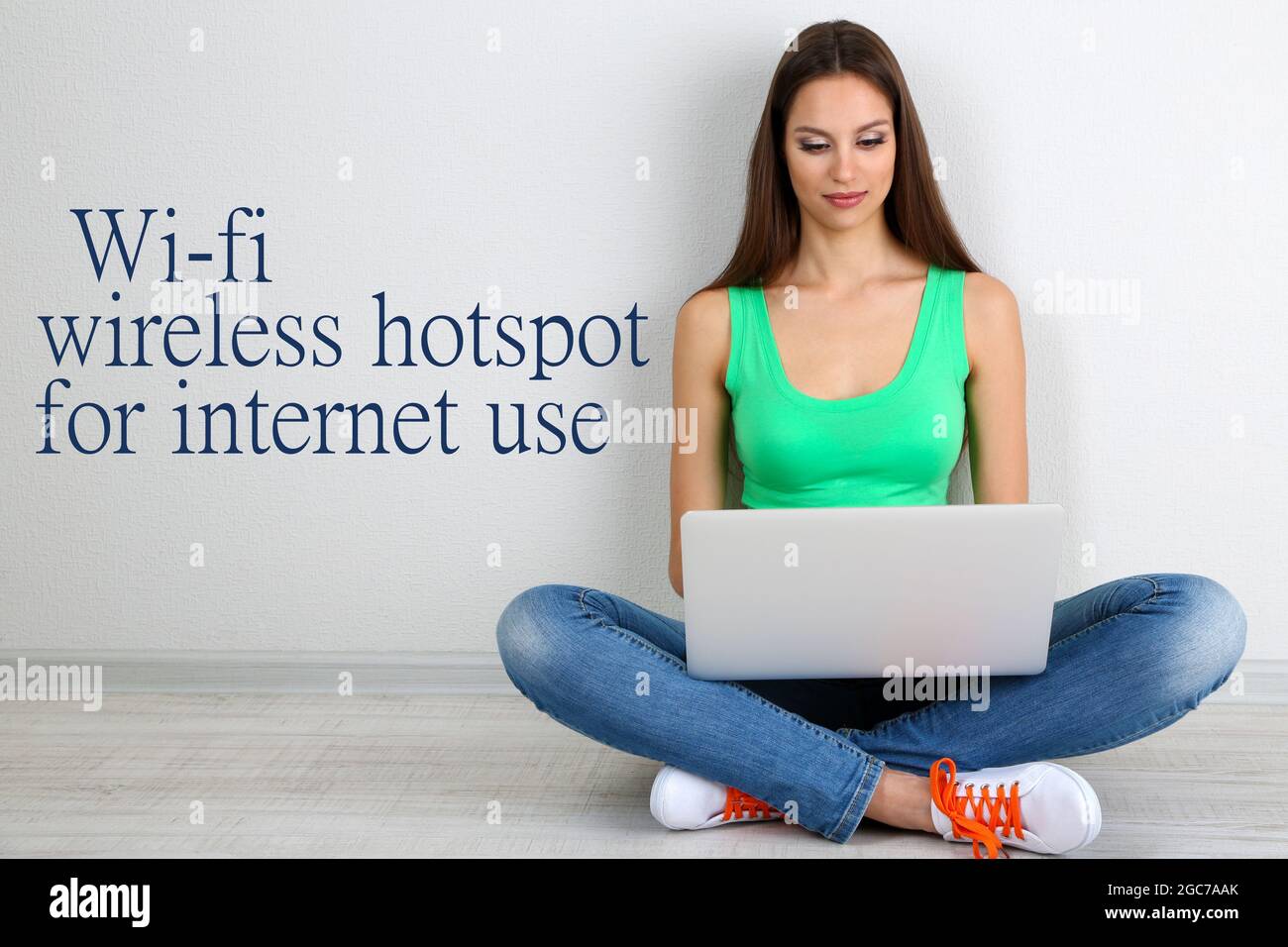 Beautiful young woman sitting with laptop in room Stock Photo - Alamy