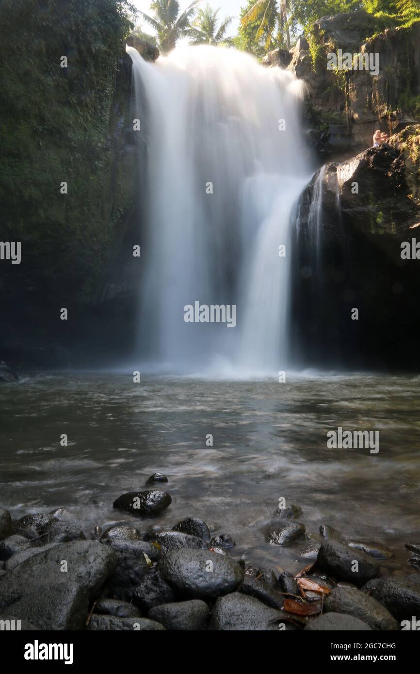 a large waterfall over some water Stock Photo - Alamy