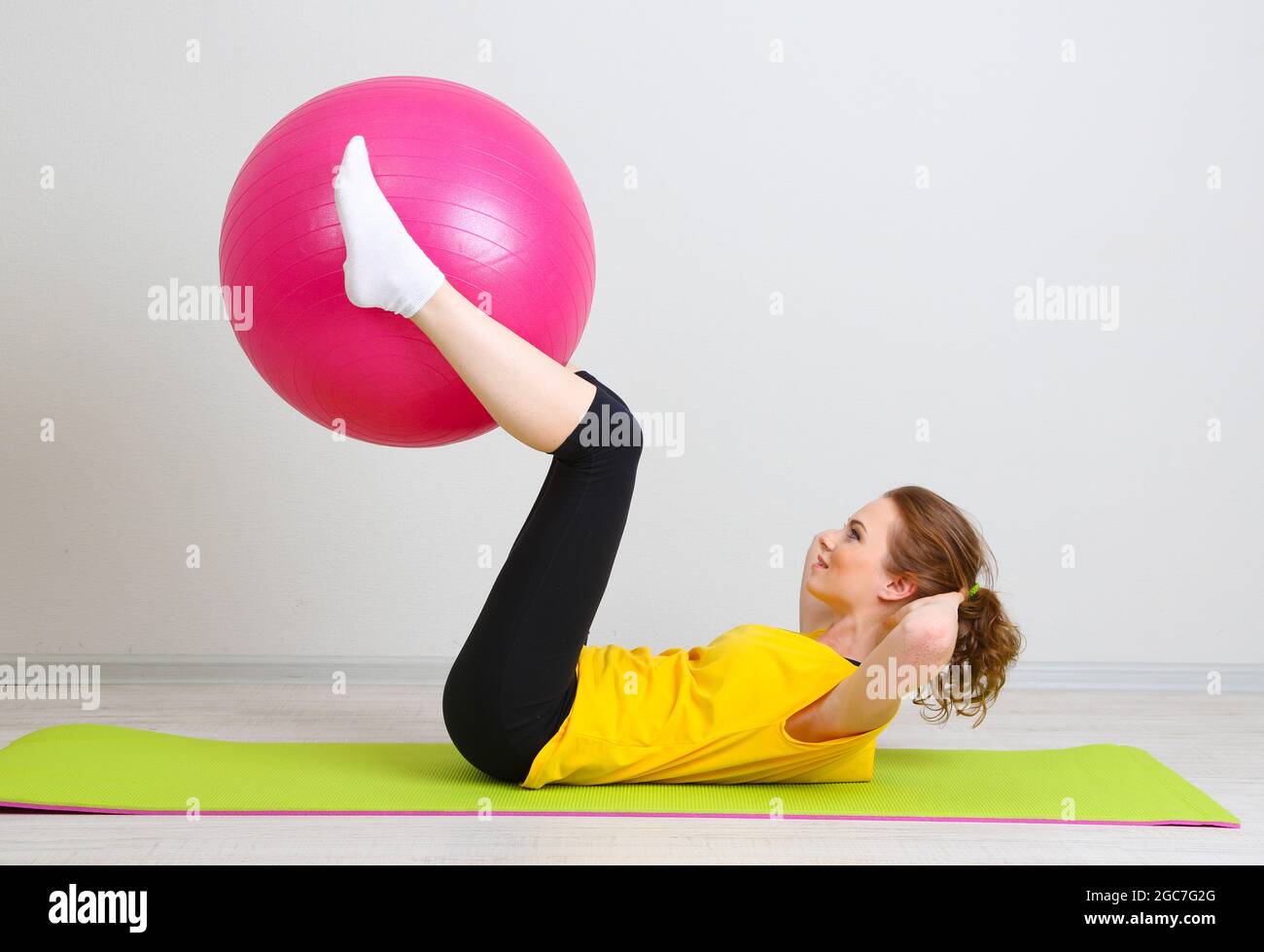 Portrait of beautiful young woman exercises with gym ball Stock Photo ...