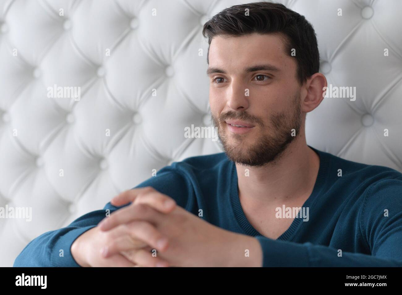 Portrait of handsome young man smiling in studio Stock Photo - Alamy