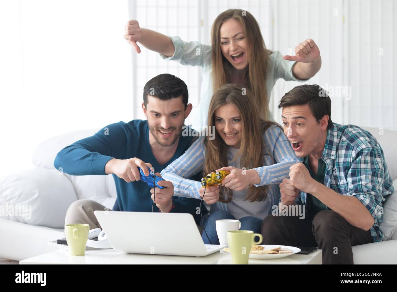 Portrait of people playing computer game with laptop Stock Photo - Alamy