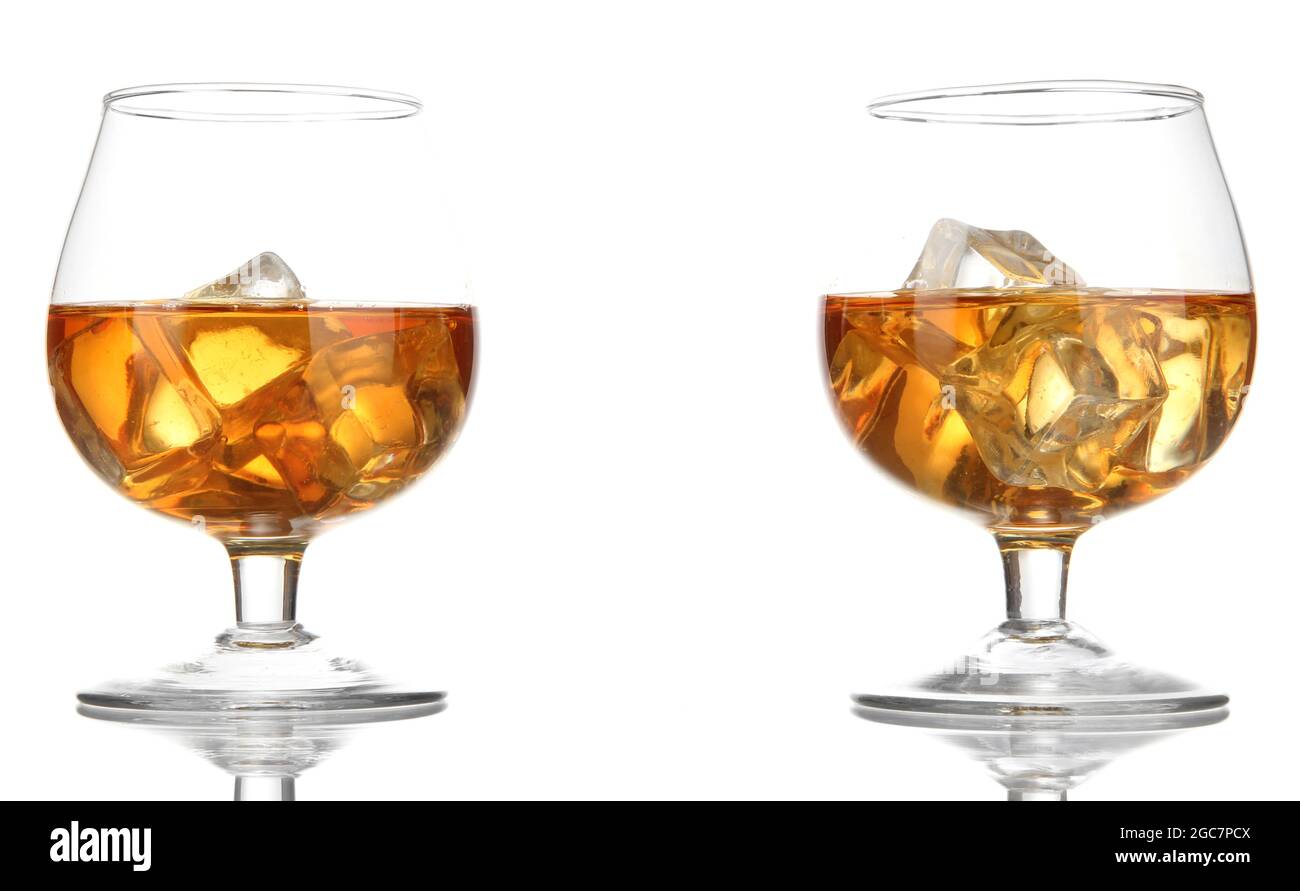 Brandy glasses with ice isolated on white Stock Photo - Alamy