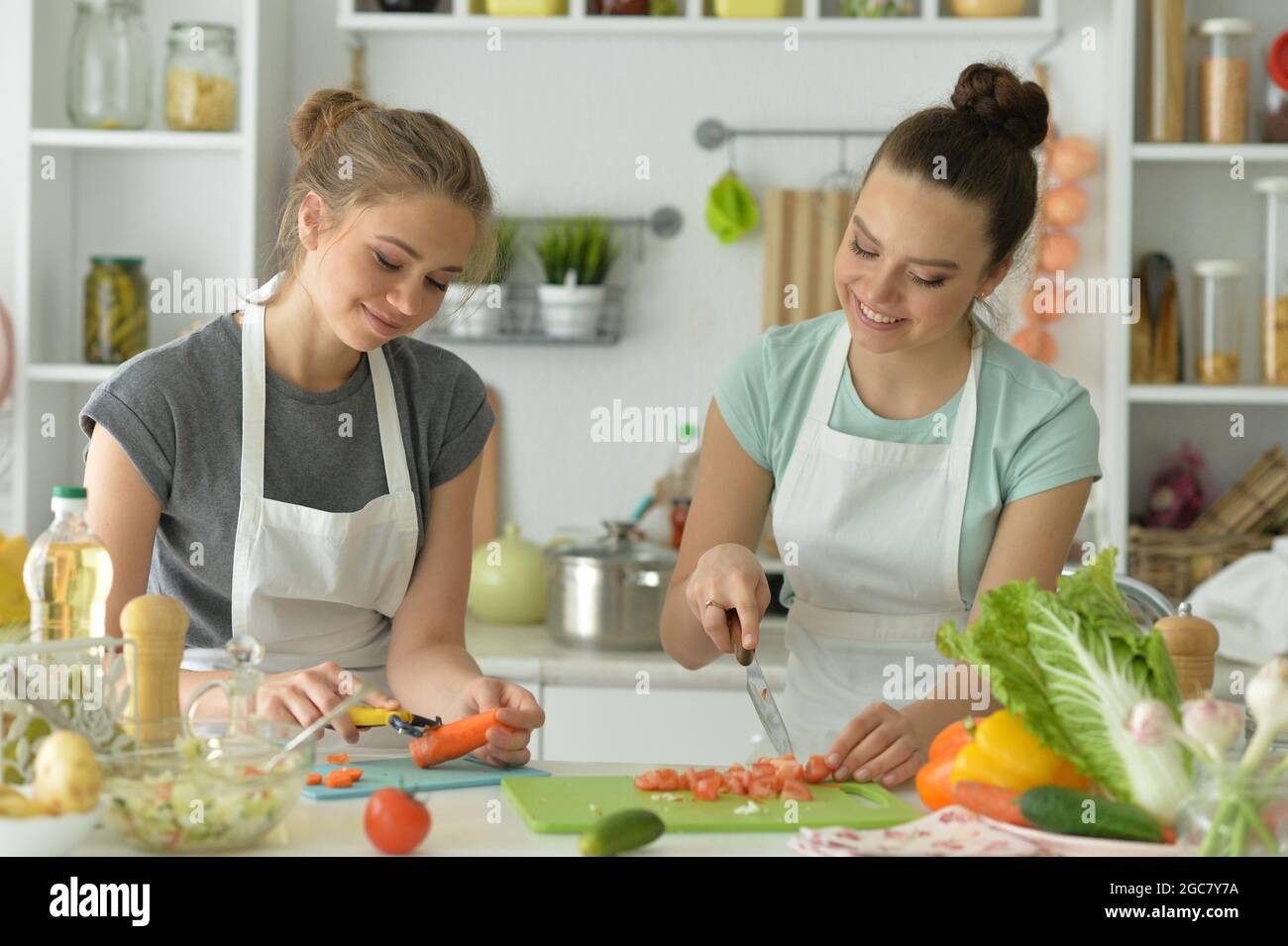 Portrait of beautiful teenagers cooking in kitchen Stock Photo - Alamy