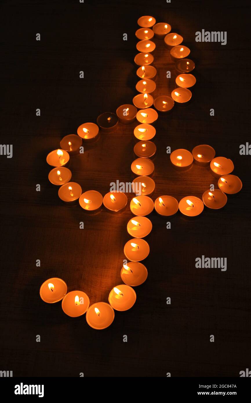 Burning candles as treble clef on dark background Stock Photo - Alamy