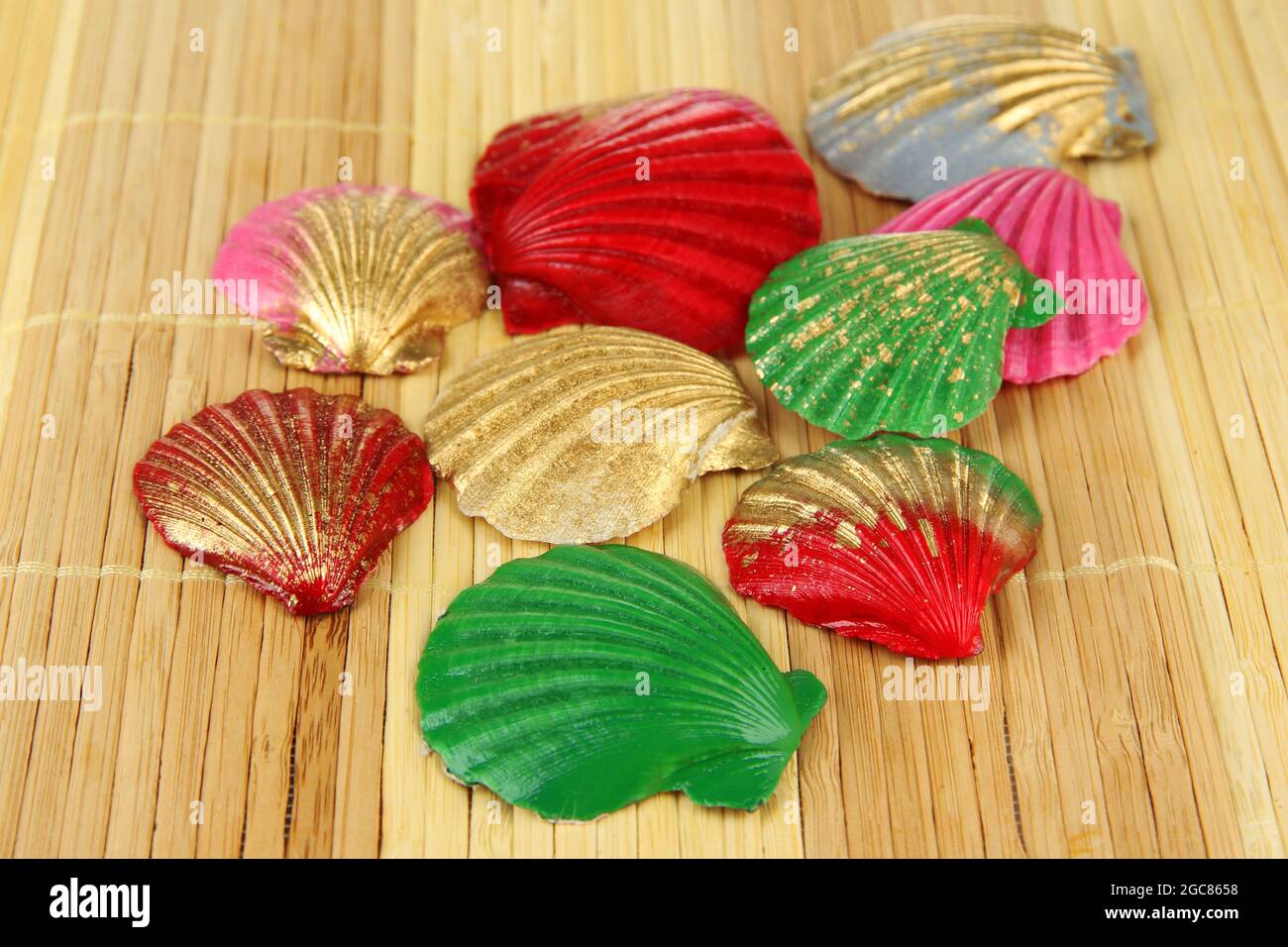 Colorful seashells on bamboo mat background Stock Photo - Alamy