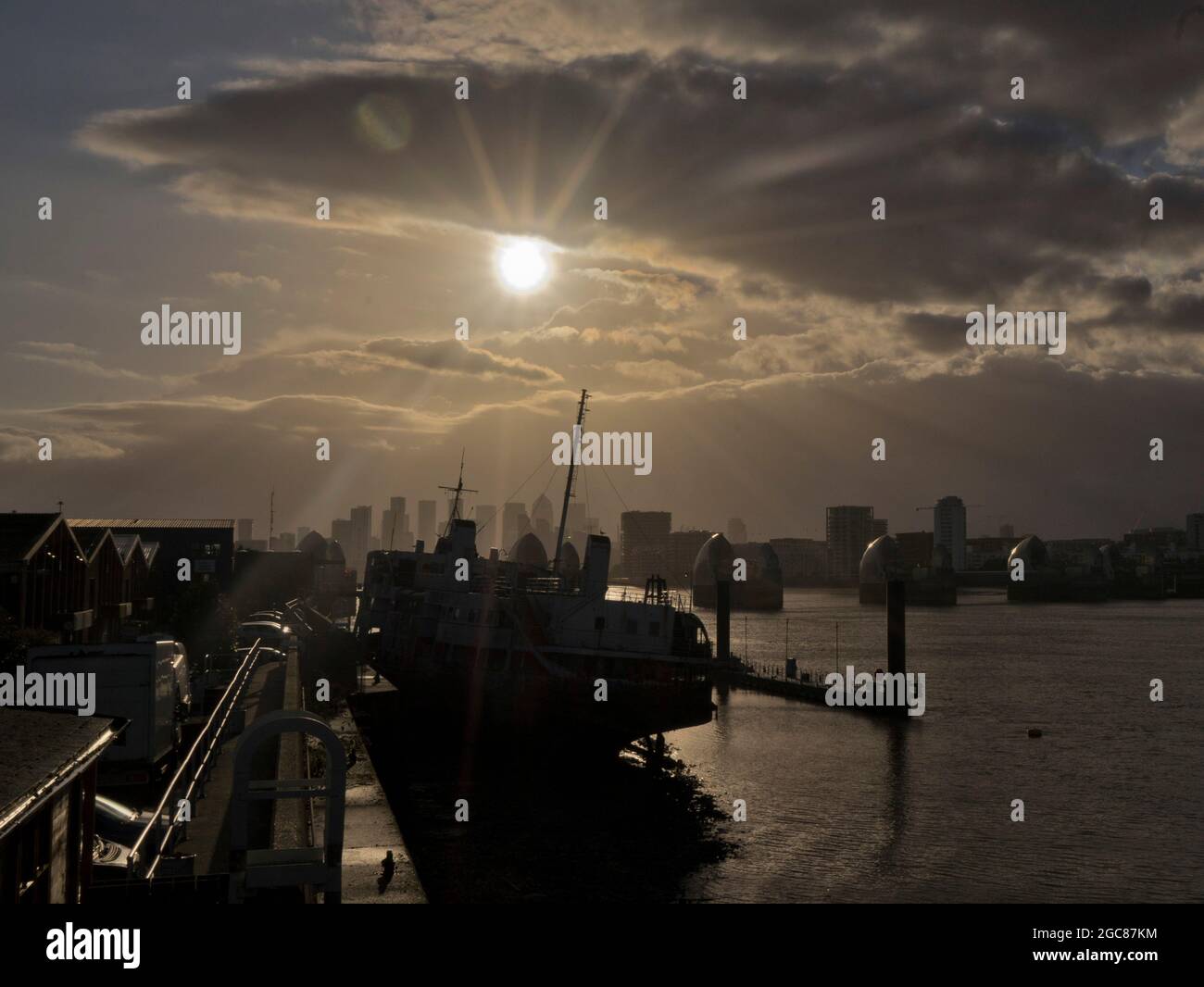 Views of river Thames barrier and Canary Wharf from Woolwich docks ...