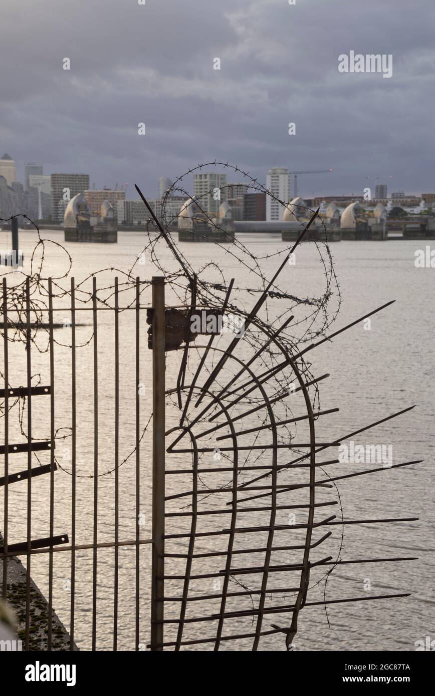 Views of river Thames barrier and Canary Wharf from Woolwich docks ...