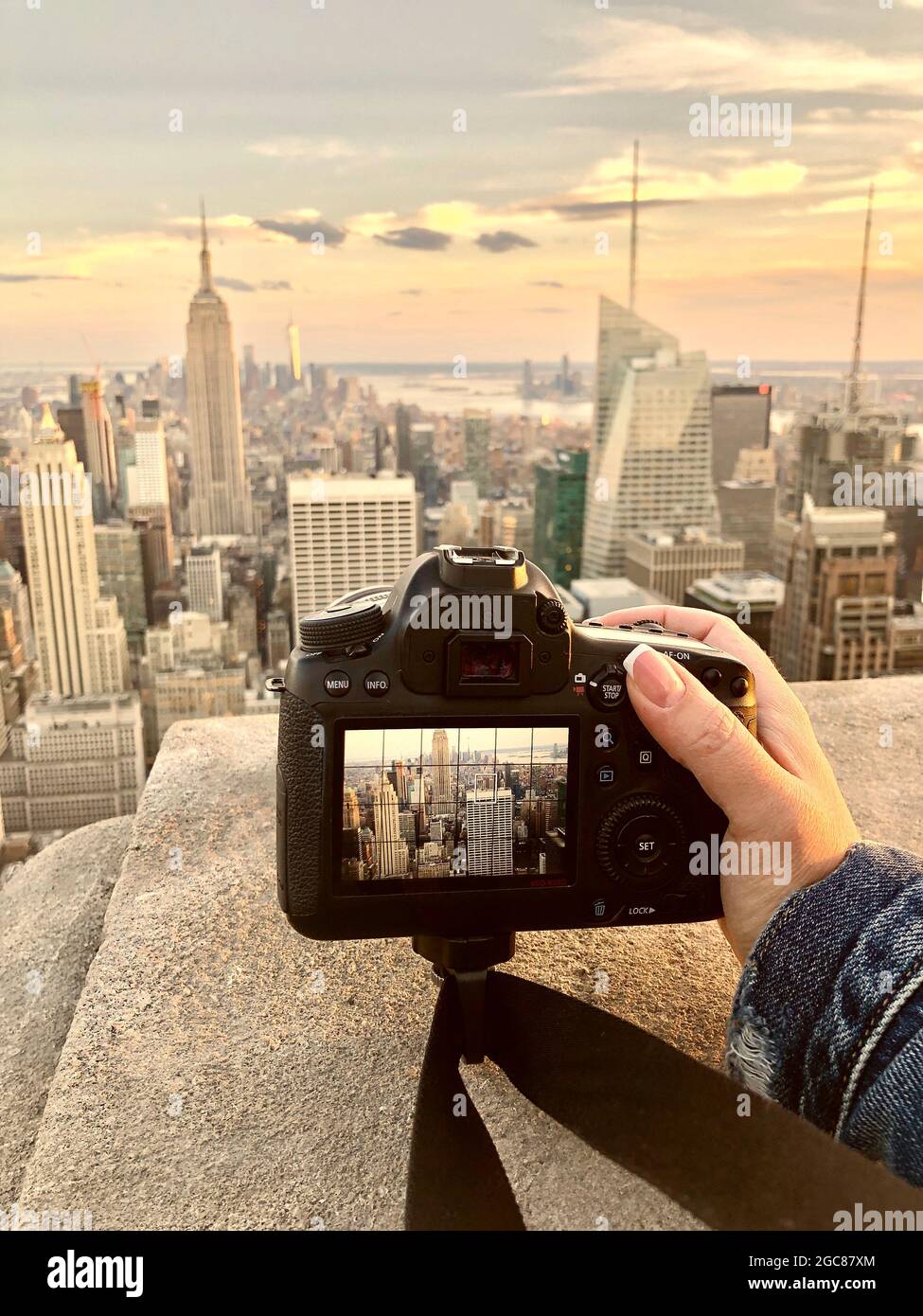 Female Hand With camera taking picture of new york city skyline on ...