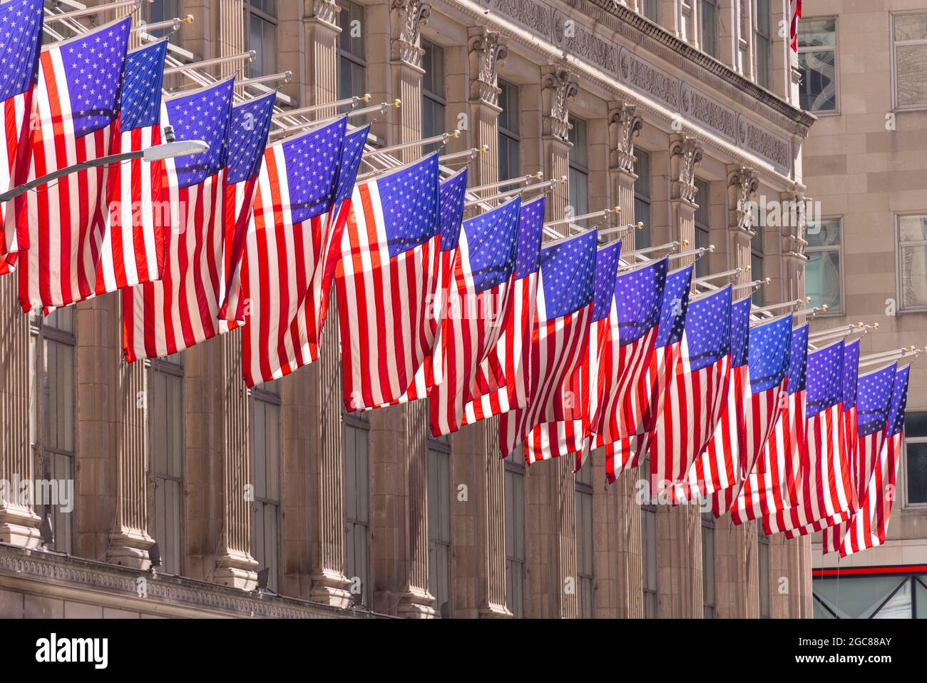 Row of rising American Flags at the Saks Fifth Avenue in Midtown ...