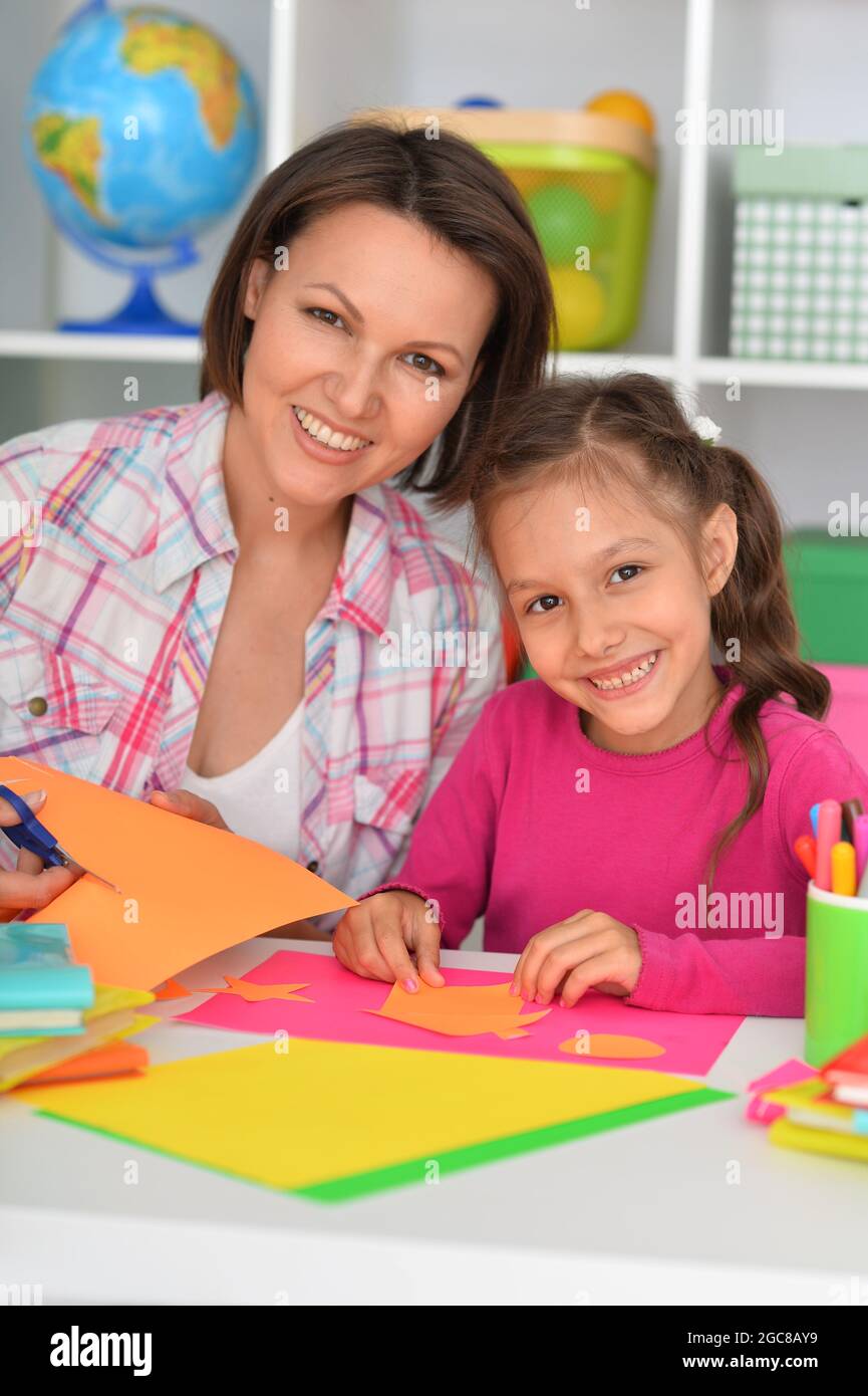 Mother teaches her cute daughter to do craft items Stock Photo - Alamy