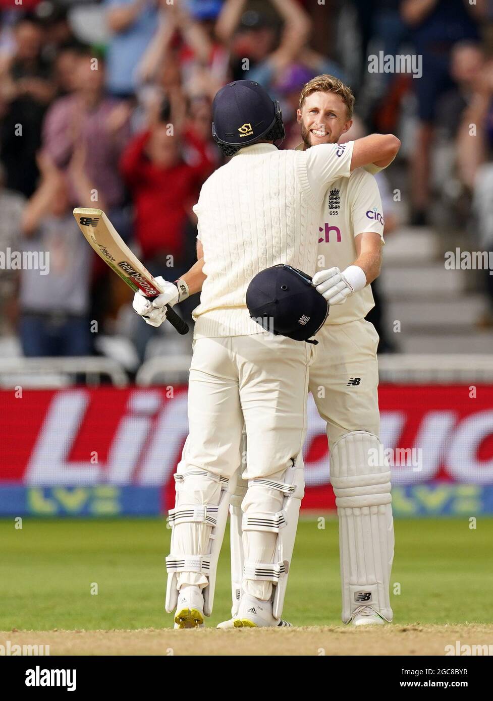 England's Joe Root (right) celebrates his century with teammate Sam ...