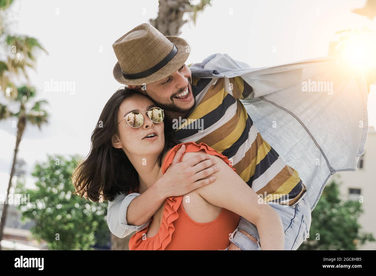 Hipster couple having fun doing piggyback ride outdoor in the city ...