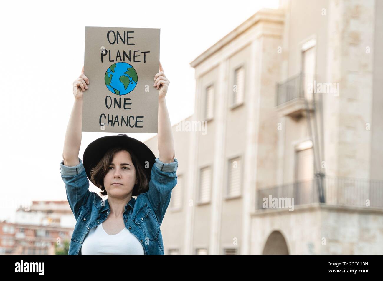 Young demonstrator activist holding banner during climate change ...