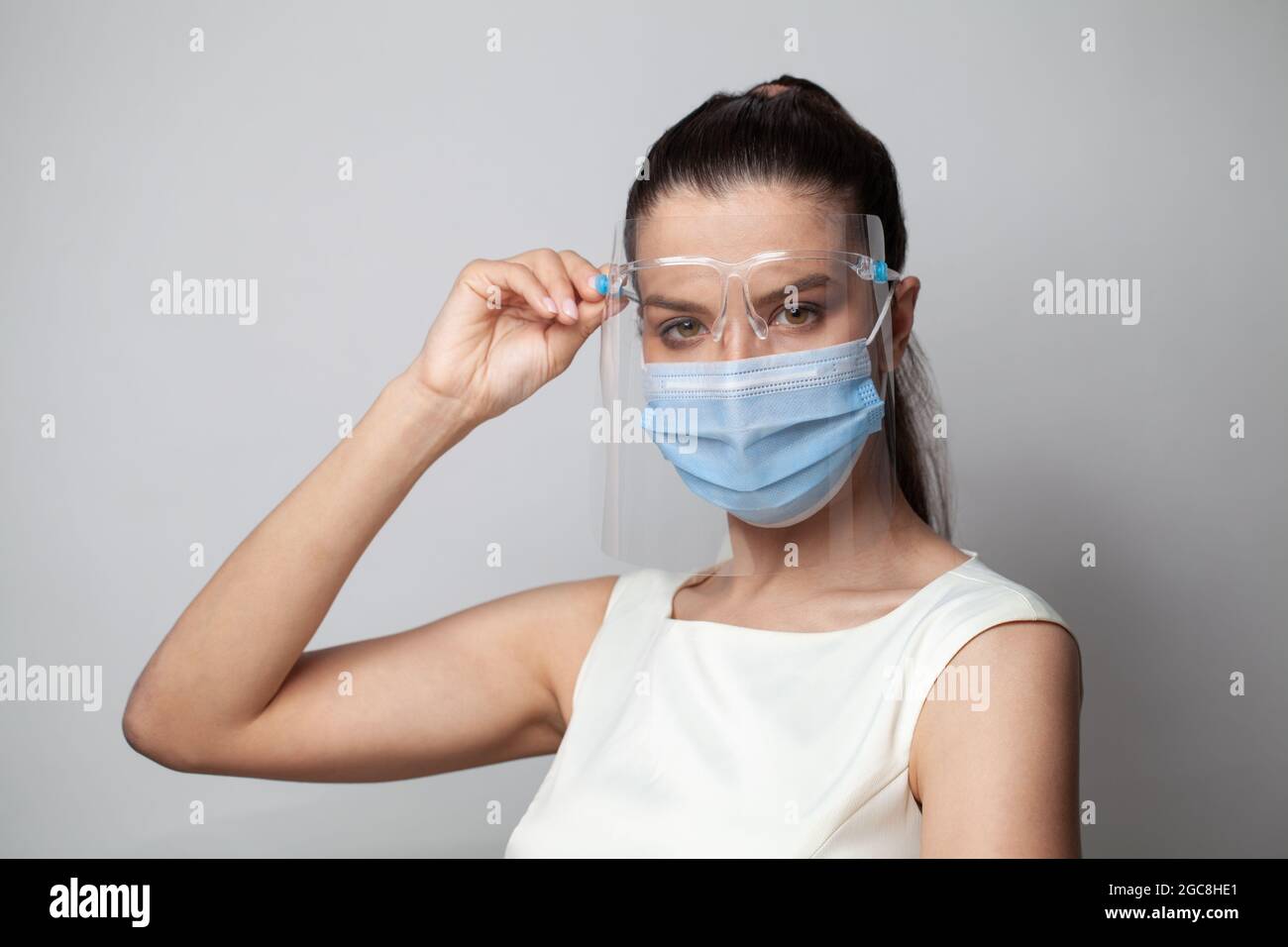 Medical practitioner woman with face shield and mask on white ...