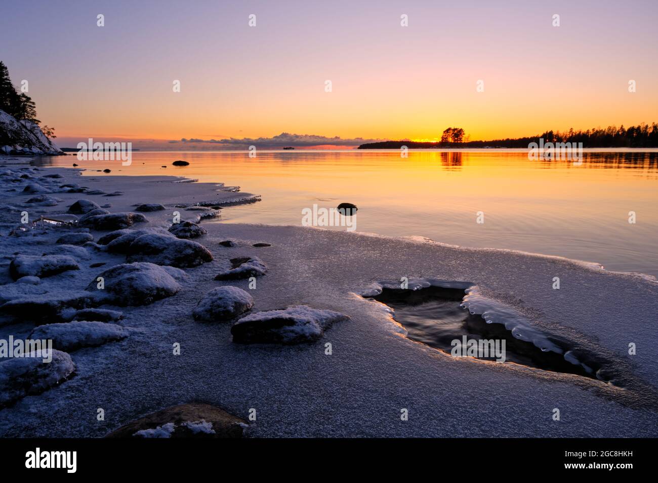 sunset on the beach and snow in the foreground Stock Photo - Alamy