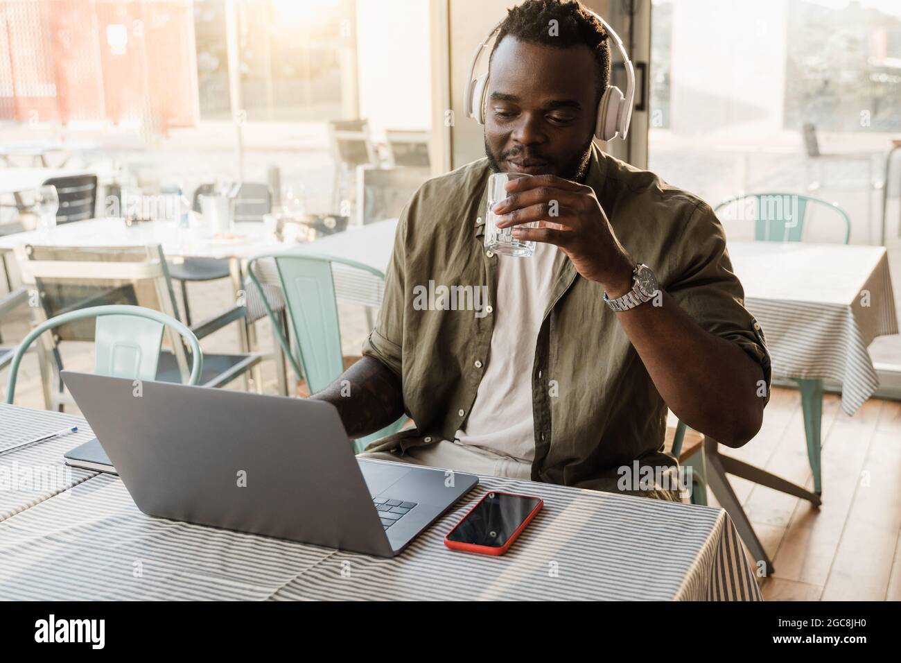 African american man using computer laptop doing video call meeting at ...