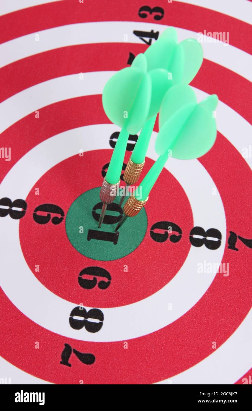 Target with darts close-up Stock Photo - Alamy