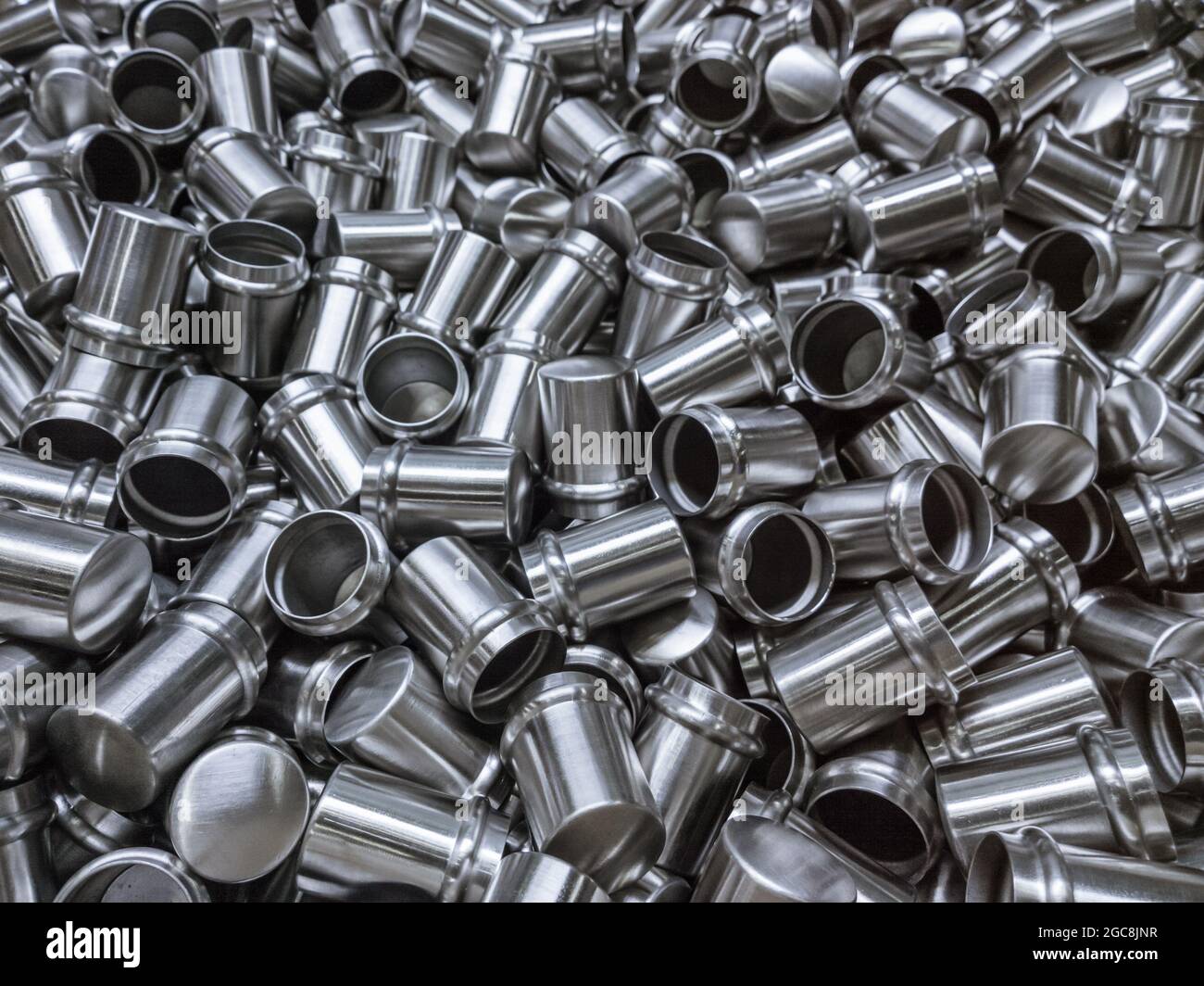 Shiny cold deformated cylindrical steel body parts selective focus ...