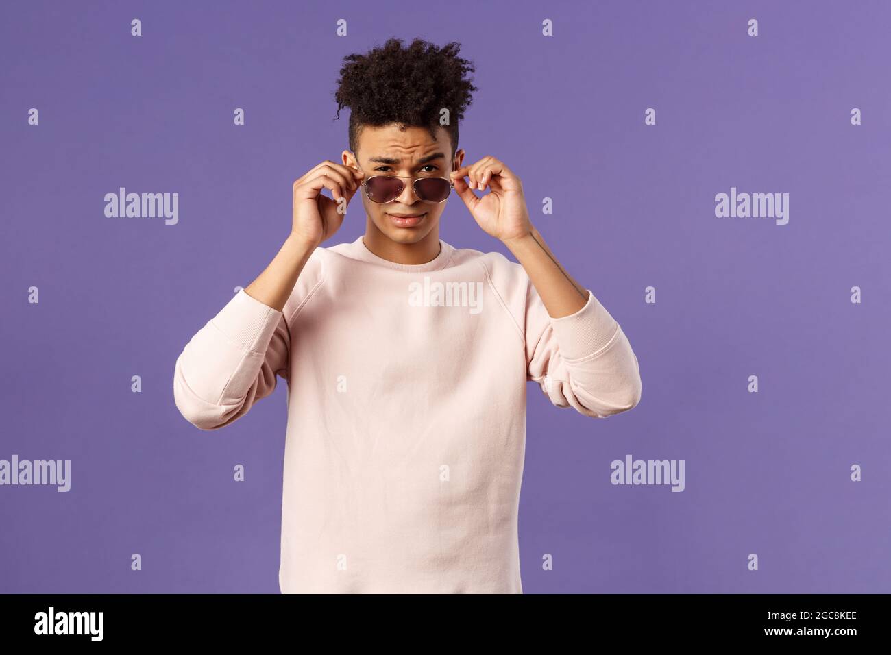 Portrait of sassy and confident young judgemental man, taking-off ...