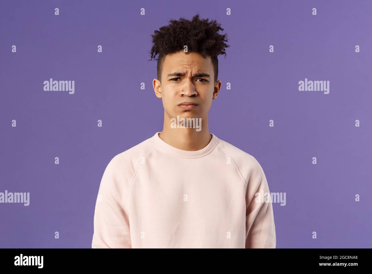 Close-up portrait of skeptical and gloomy, disappointed hispanic young ...