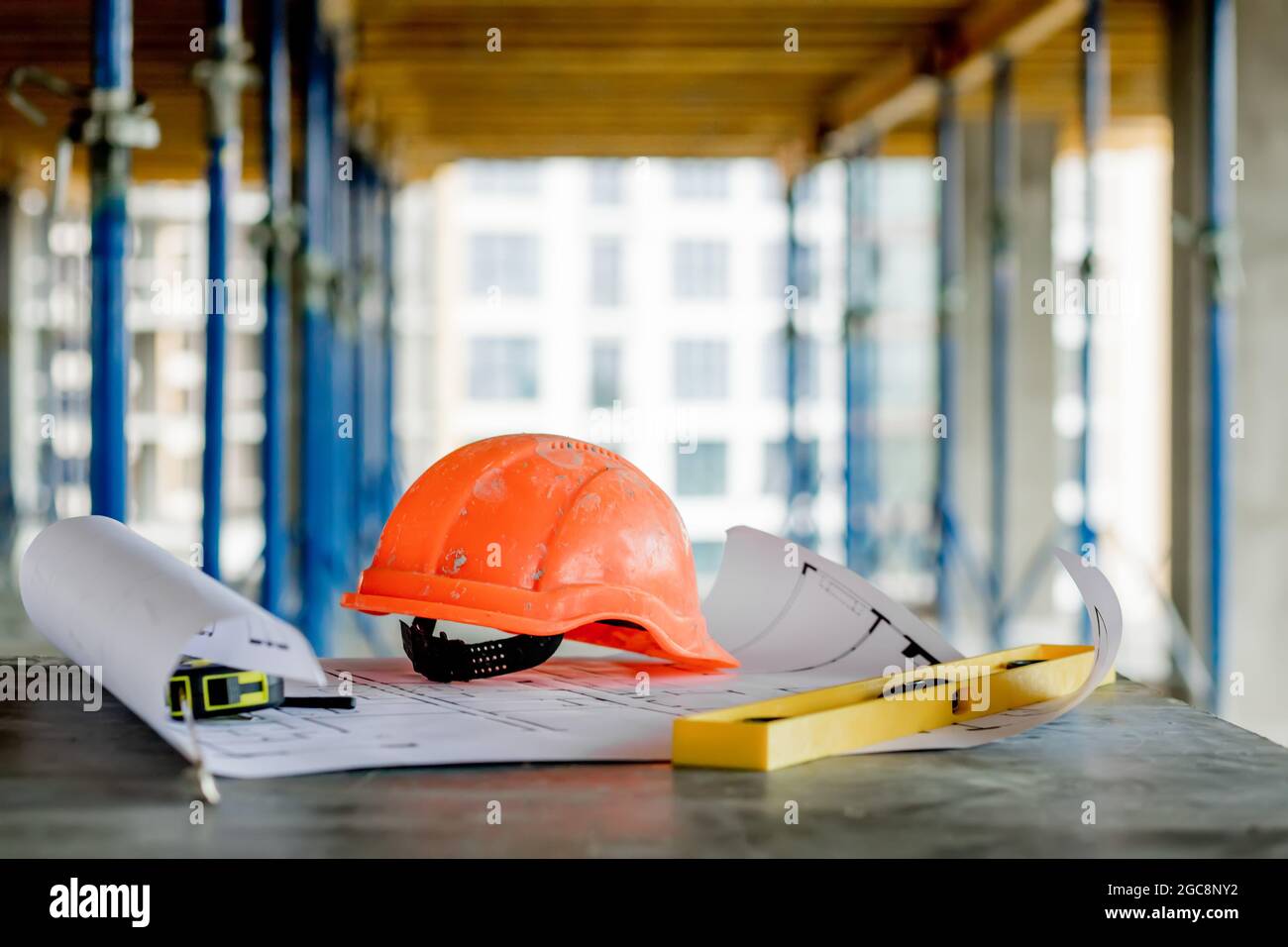 Blueprints project building, construction level and helmet, close up ...