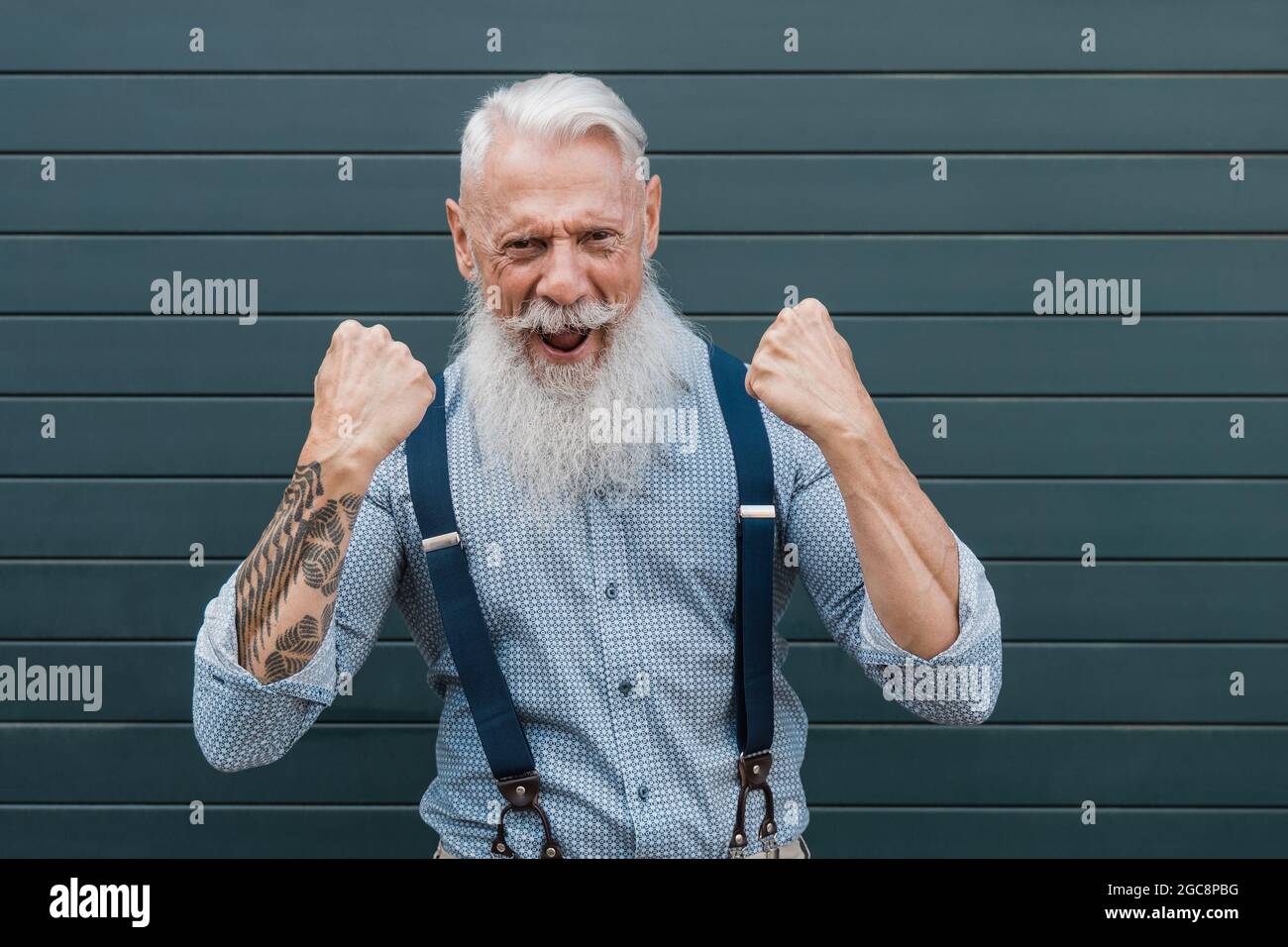 Hipster senior man celebrating victory outdoor in the city - Elderly ...