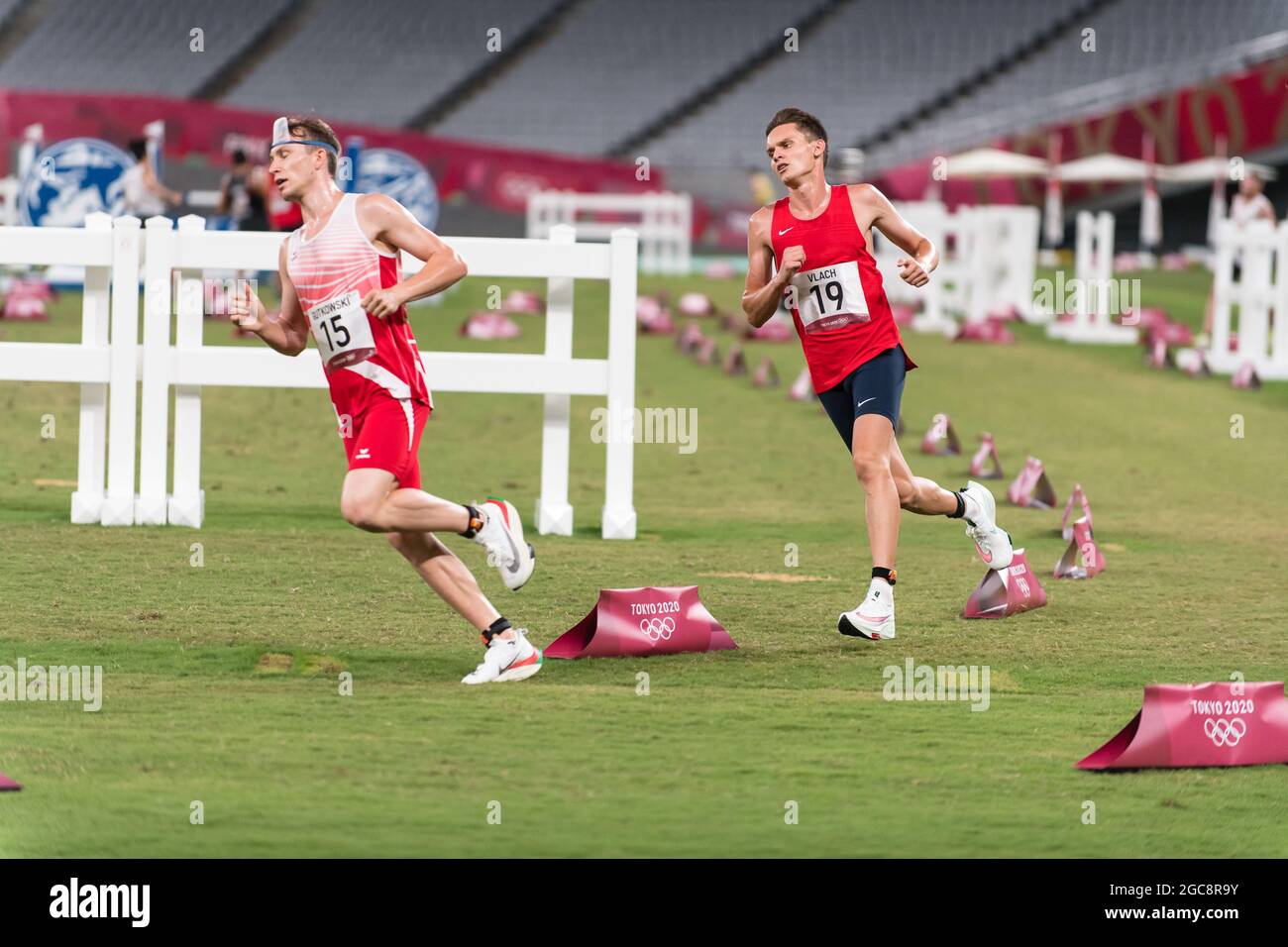 Czech athlete Martin Vlach, right, runs in laser run shooting portion ...