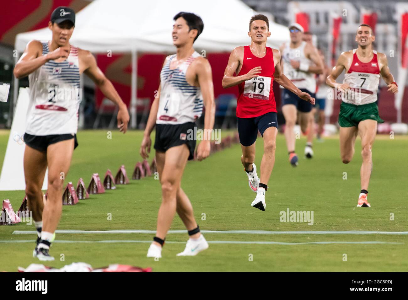 Czech athlete Martin Vlach, in red, runs in laser run shooting portion ...