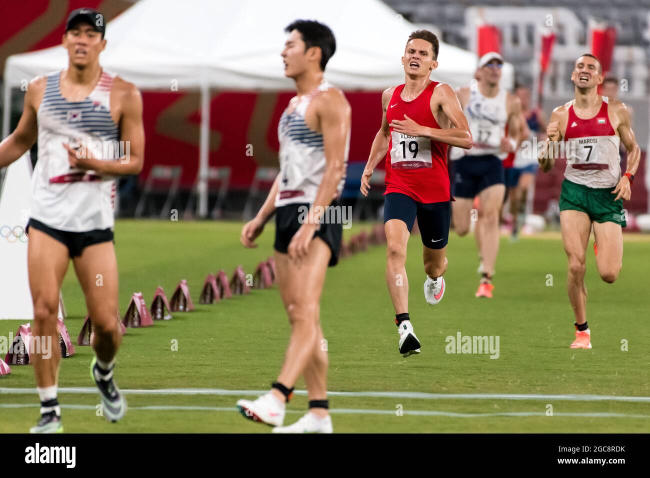 Czech athlete Martin Vlach, in red, runs in laser run shooting portion ...