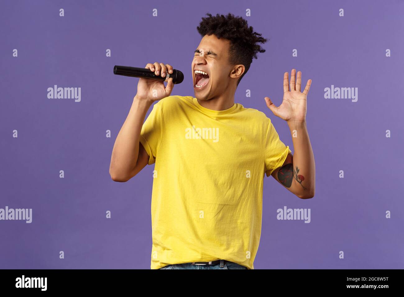 Portrait of passionate carefree young hispanic singer with dreads and ...