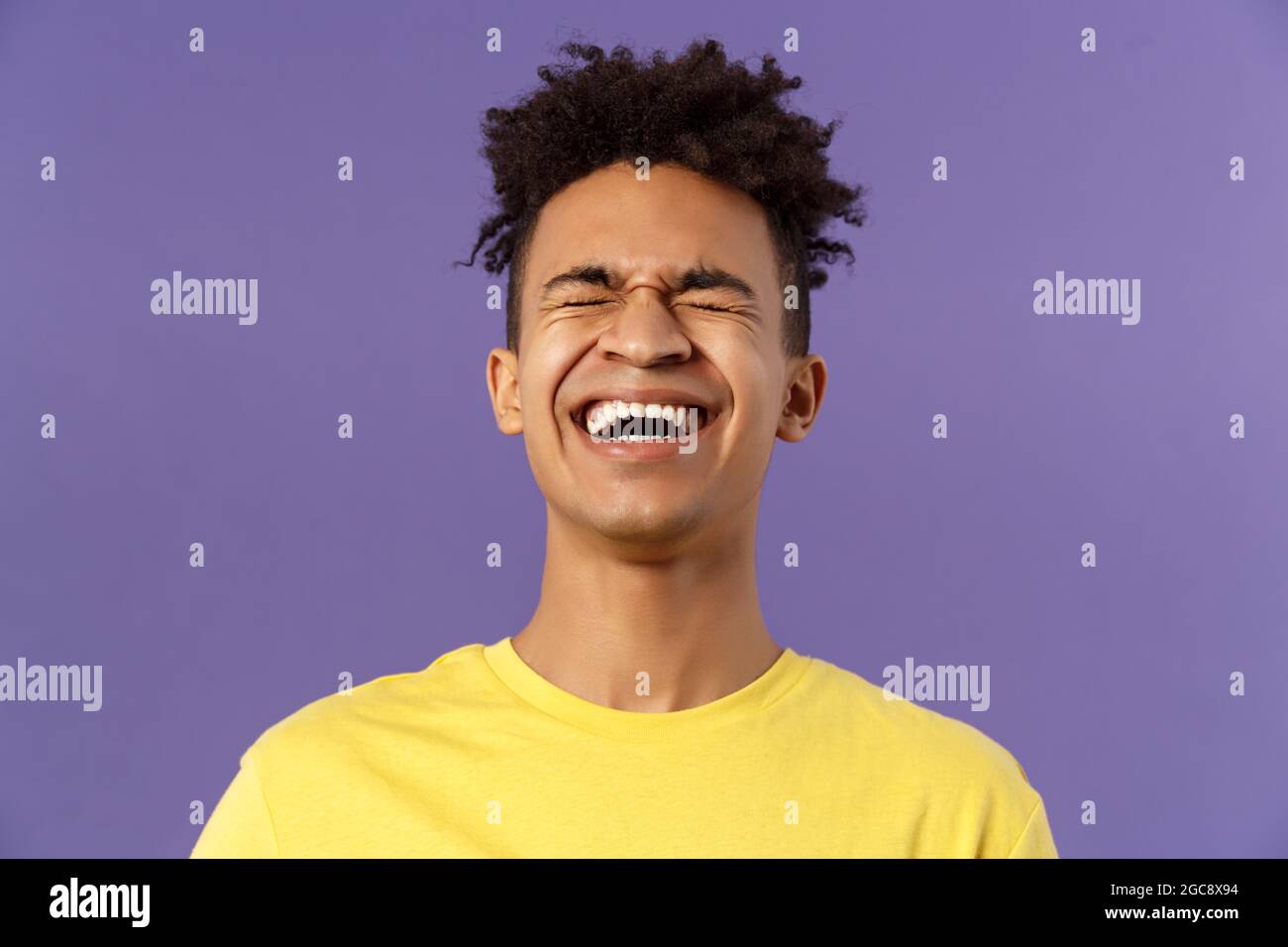 Close-up portrait of happy carefree young guy laughing loud, chuckling ...