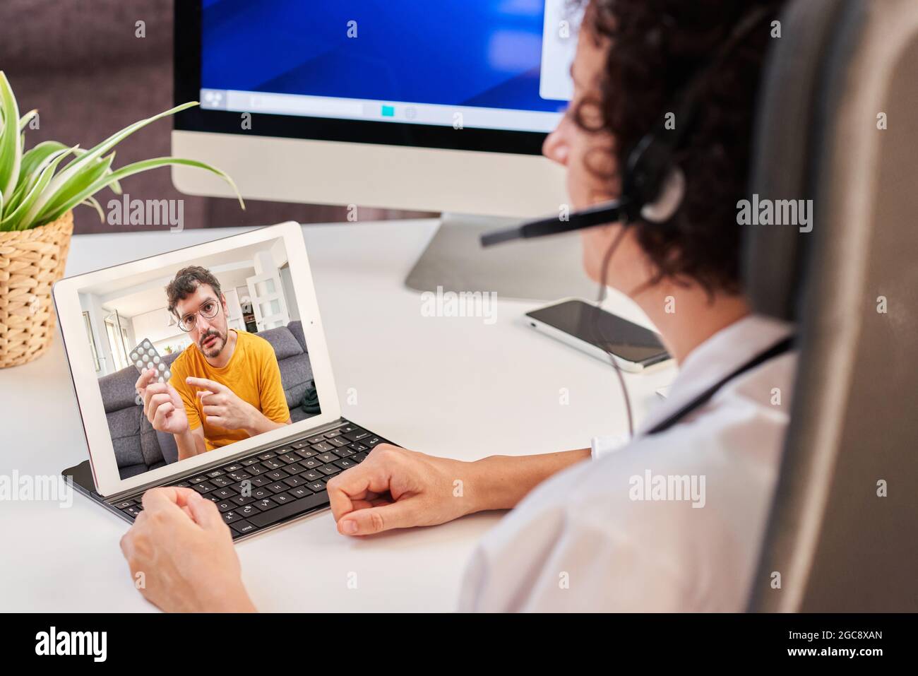 Female health insurance doctor attends to patient through video call ...