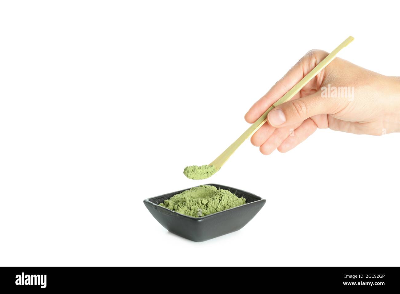 Female hand holds stick with matcha powder, isolated on white ...