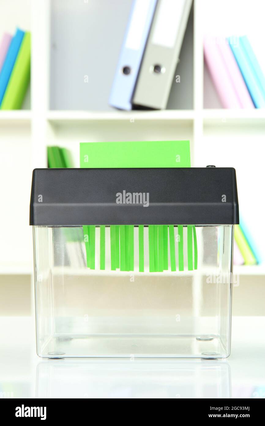 Paper shredder machine, on office interior background Stock Photo - Alamy