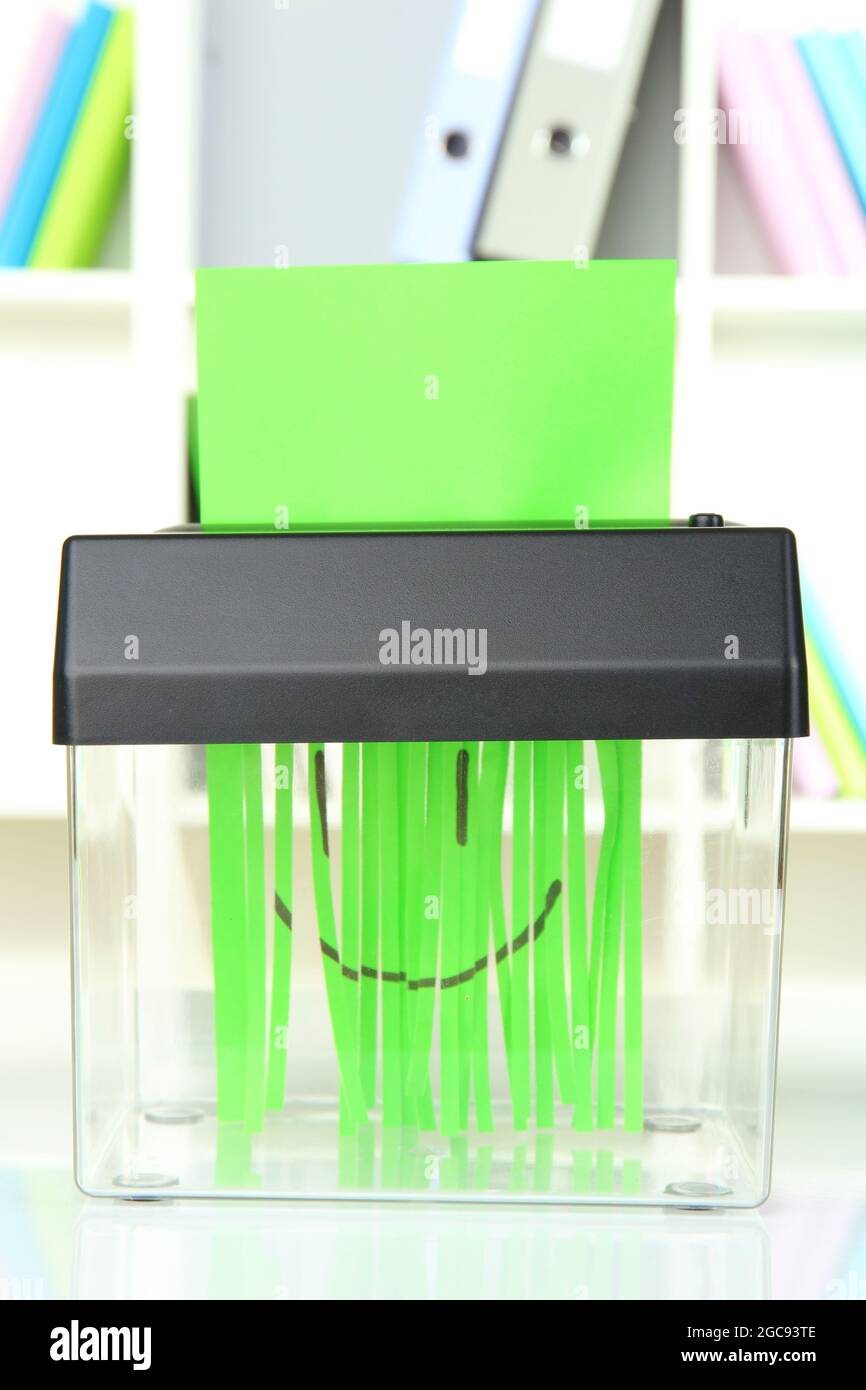 Paper shredder machine, on office interior background Stock Photo - Alamy