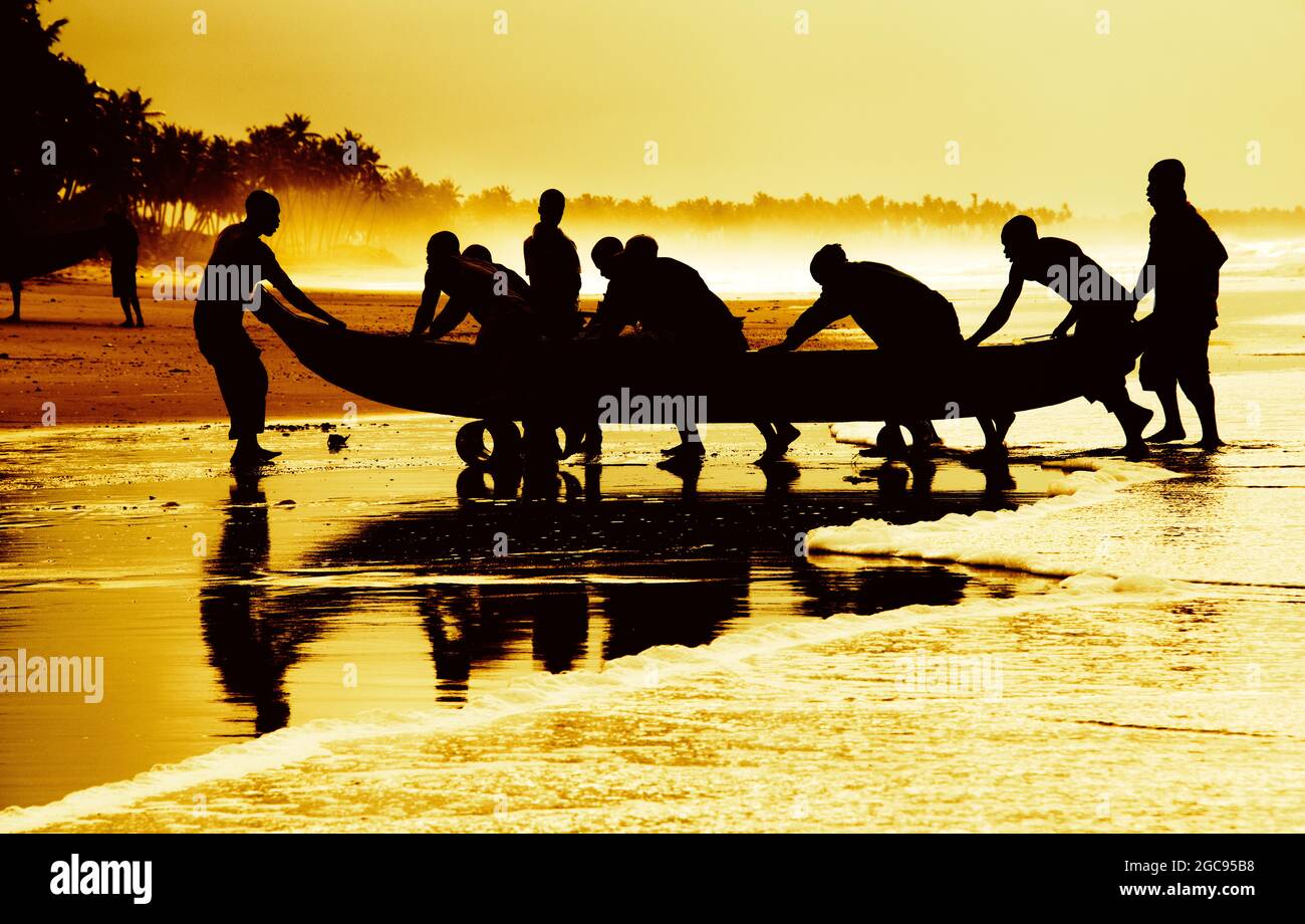 Fishermen pulling boat out ocean hi-res stock photography and images ...