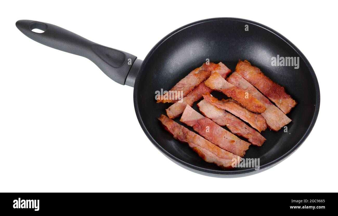 Fried bacon in frying pan isolated on white Stock Photo - Alamy
