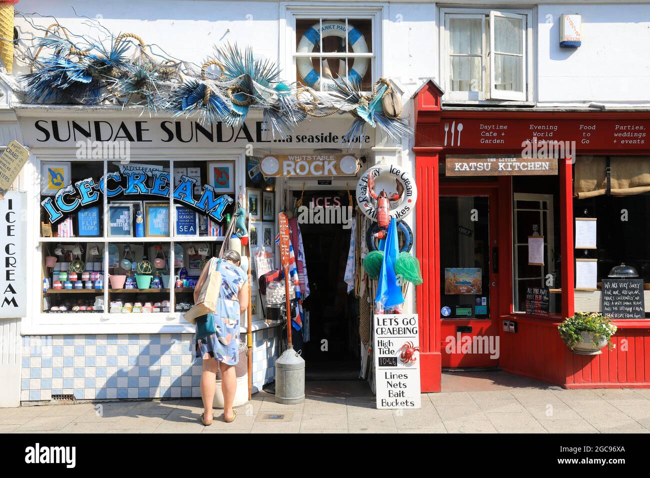Independent shops and cafes on pretty Harbour Street, in coastal ...