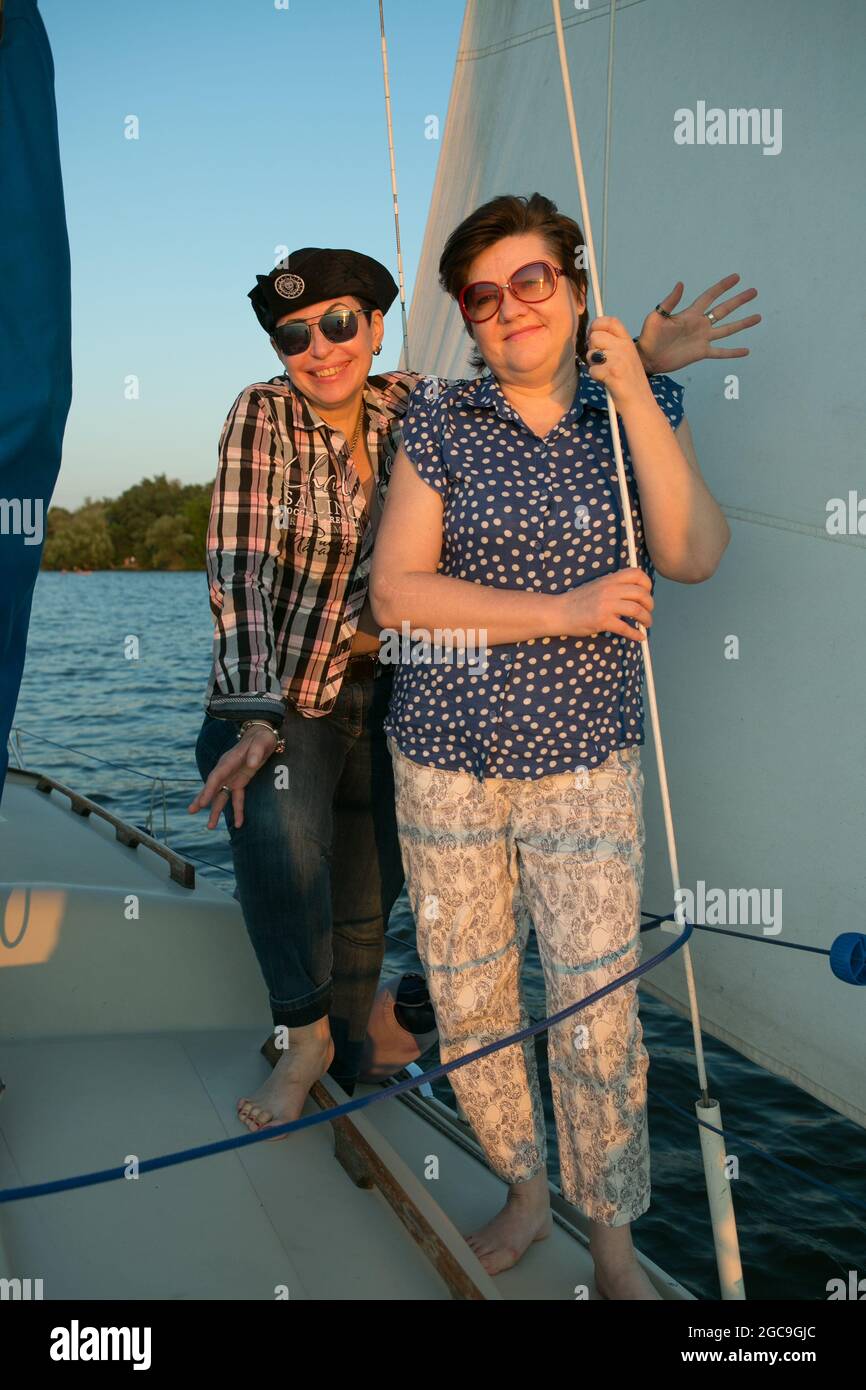 A luxurious yacht vacation. Happy pretty middle aged women girlfriend ...