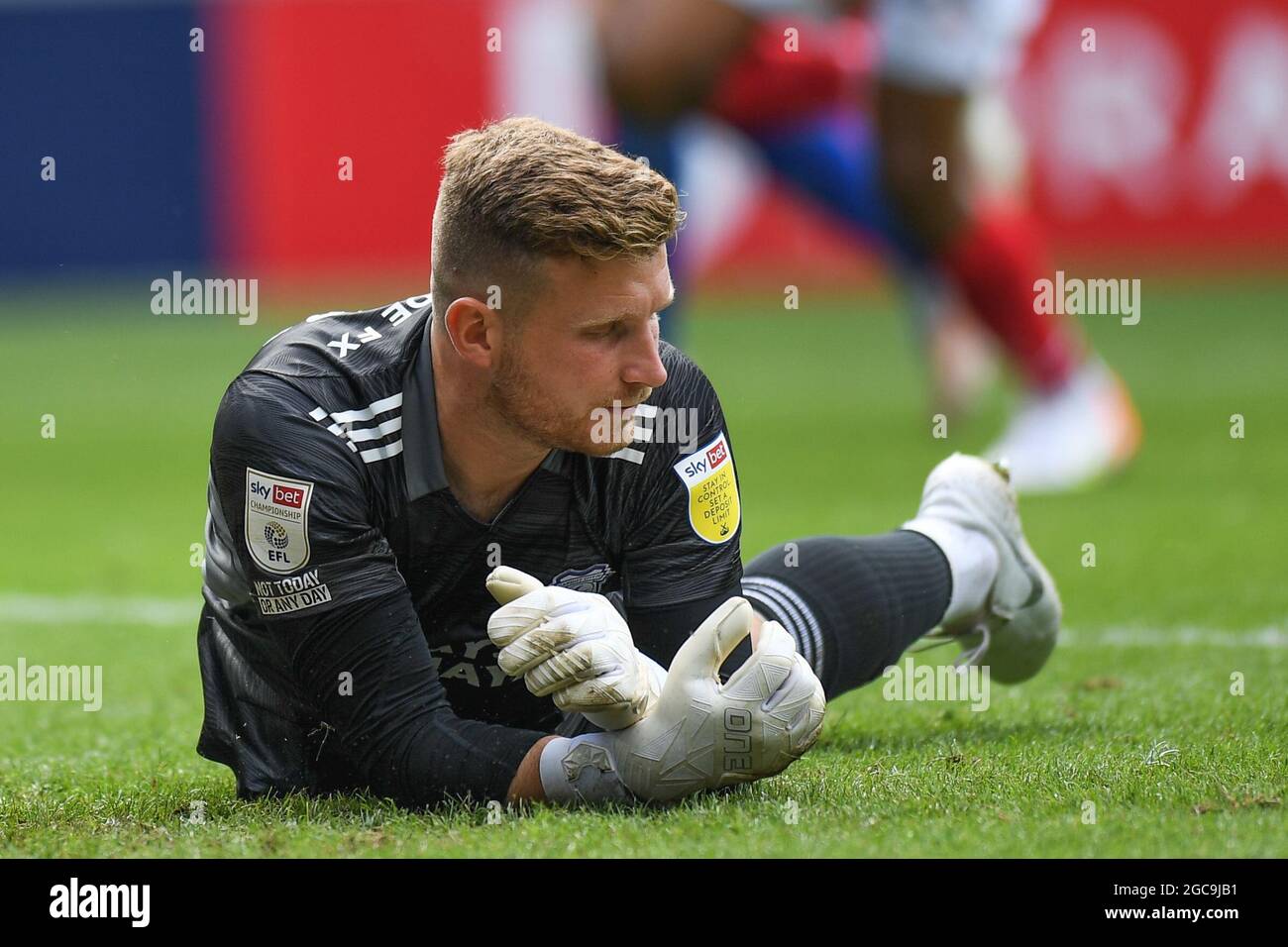 Dillon Phillips #1 of Cardiff City following Toby Sibbick #20 of ...