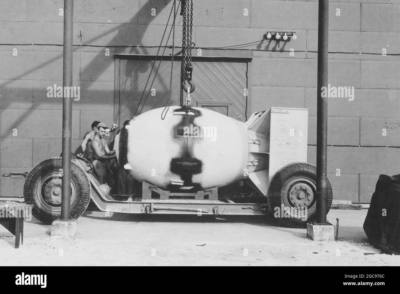 The atomic bomb Fat Man (dropped on Nagasaki) being placed on a trailer ...