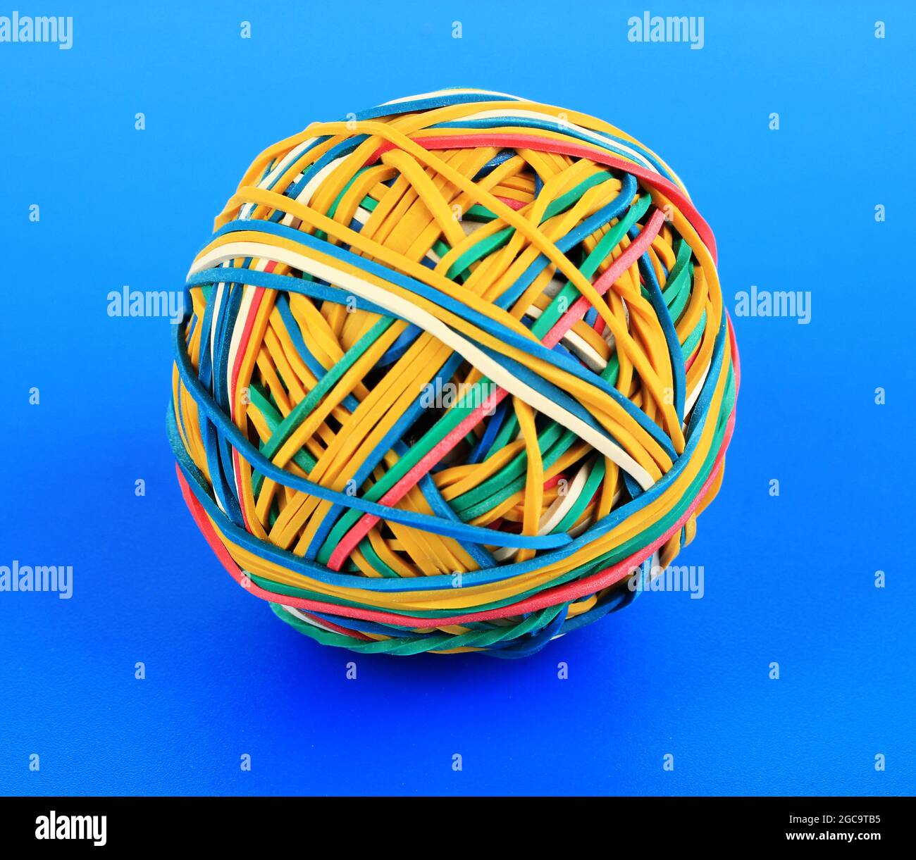 Colorful rubber bands on blue background Stock Photo - Alamy