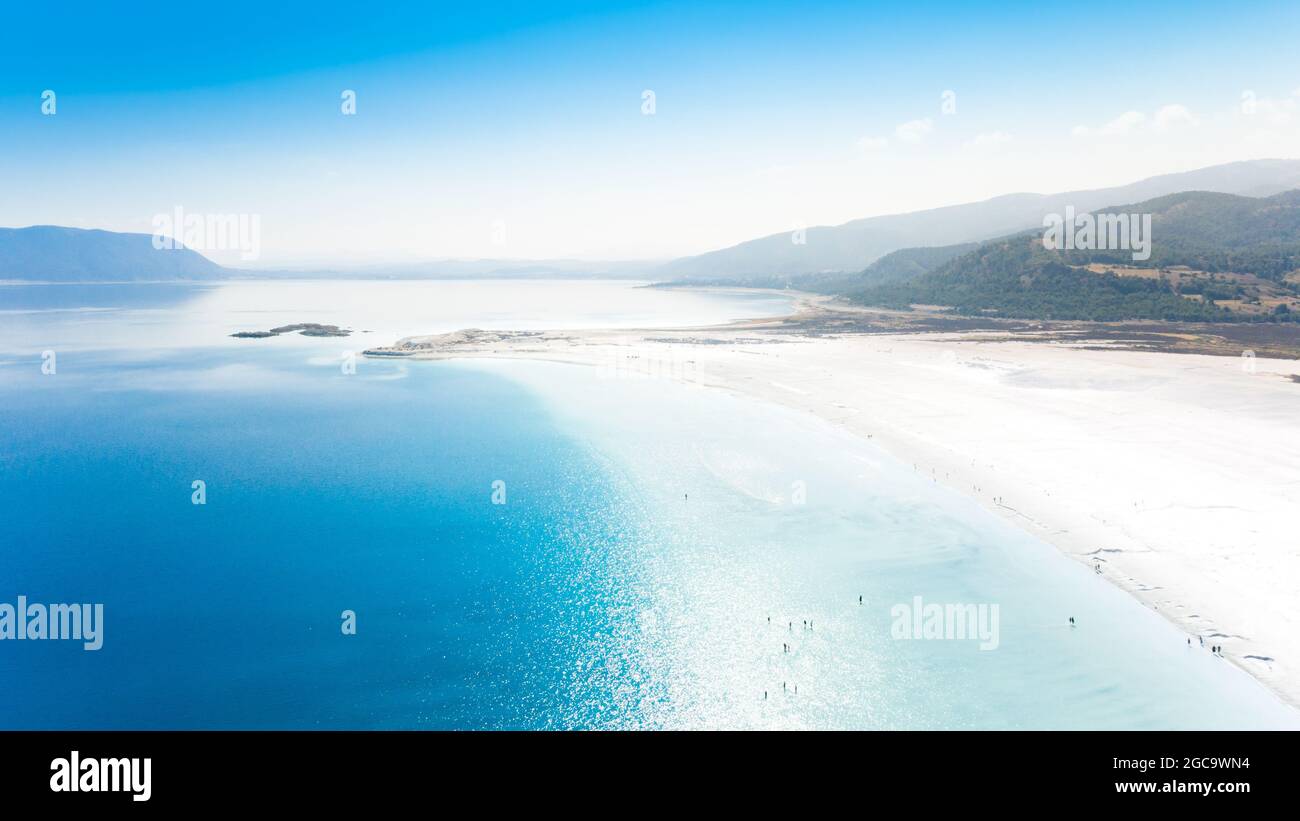 Aerial view over the clear beach and turquoise water of Salda lake ...