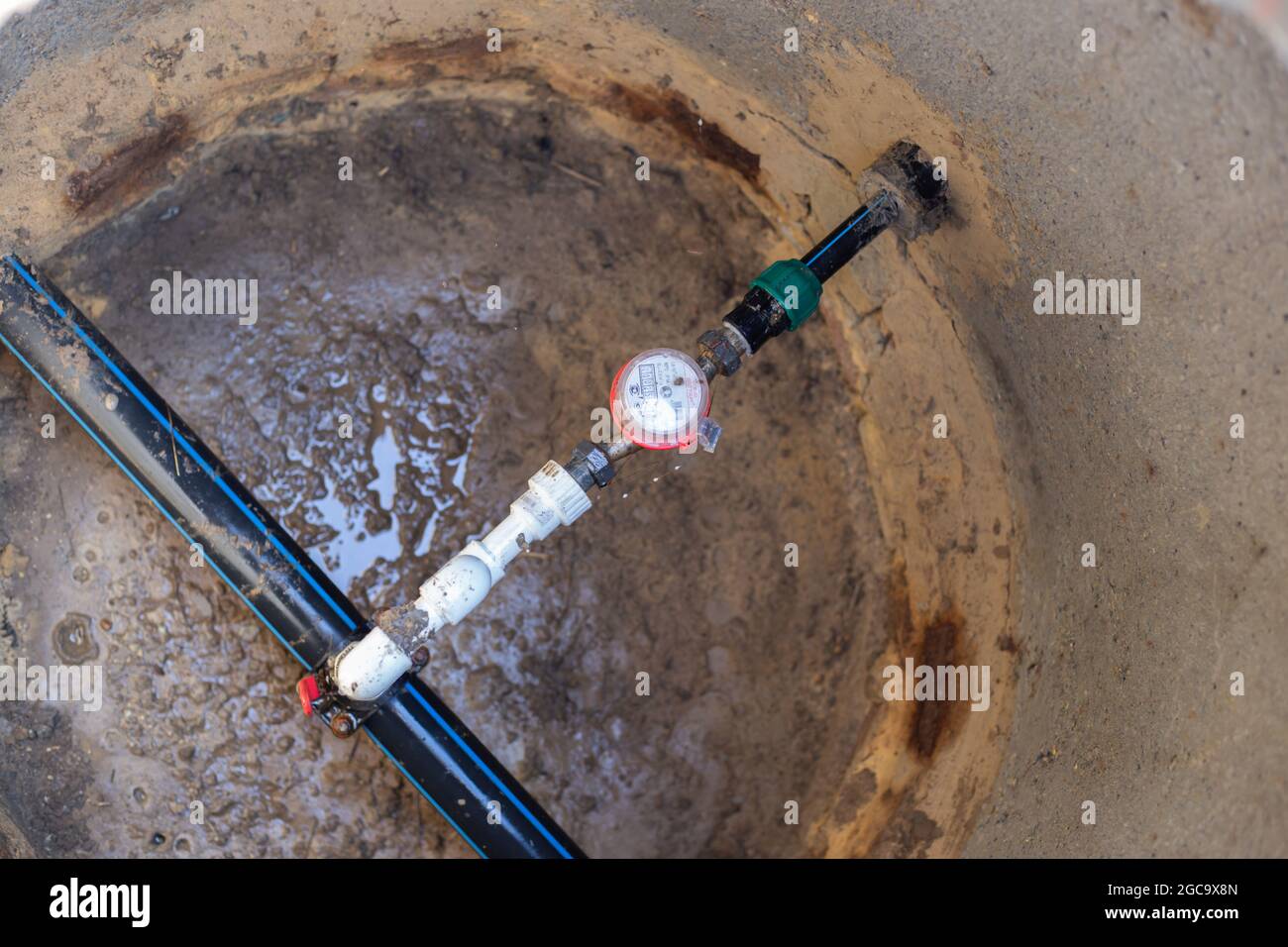 Anapa, Russia-07.24.2021:Water meter in an underground well. Pipeline ...