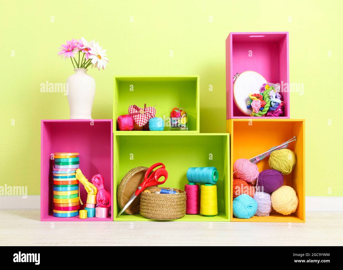 Colorful shelves of different colors with utensils on wall background ...