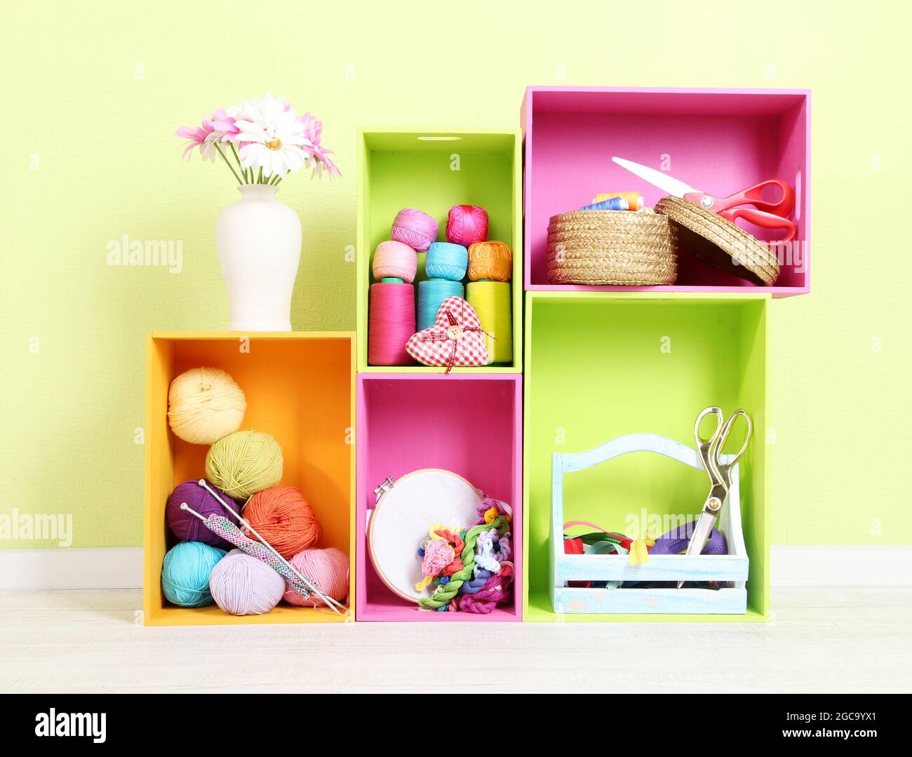 Colorful shelves of different colors with utensils on wall background ...
