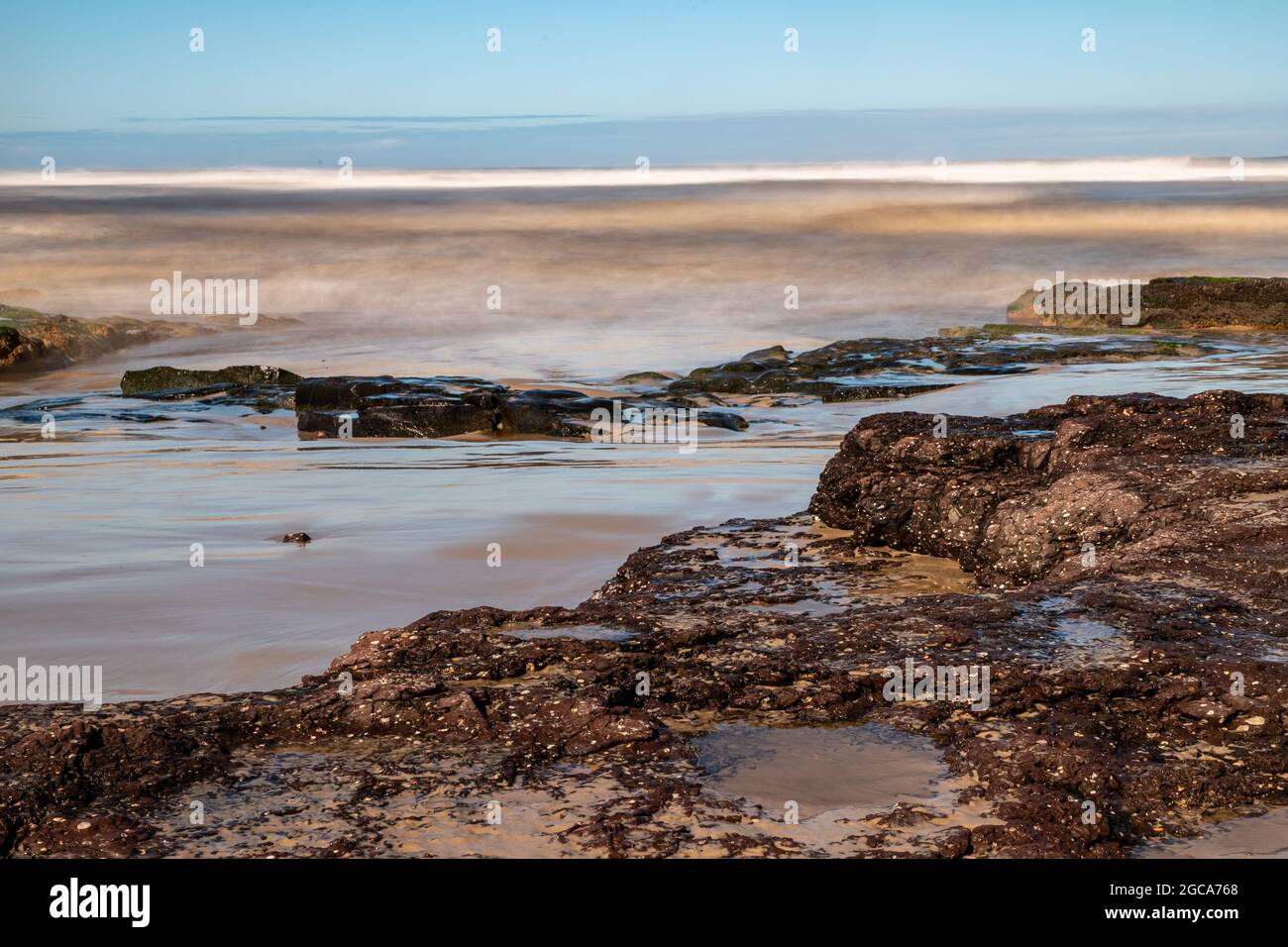 Sand, rocks and waves in a beach, Torres, Rio Grande do Sul, Brazil ...